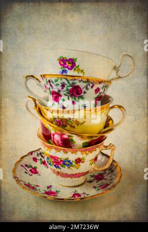 A beautiful stack of vintage porcelain tea cups and saucers with ...
