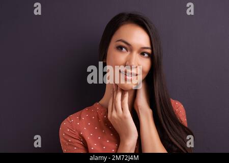 Shes beautiful in her casual nature. Studio shot of an attractive young ...