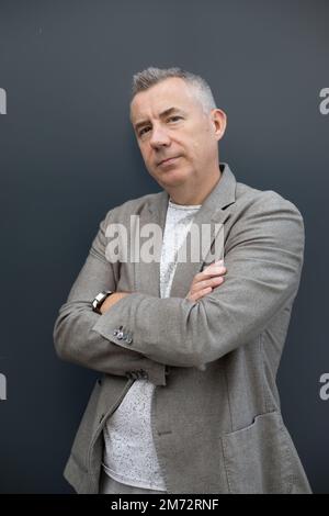 Portrait of serious gray haired boss, man looking at camera thinking ...