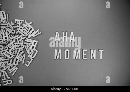 AHA MOMENT in wooden English words language capital letters spilling ...