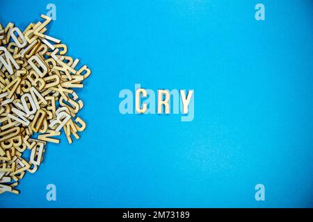 CRY in wooden English words language capital letters spilling from a ...