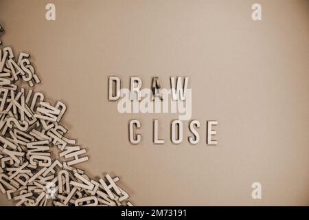 DRAW A LONG BOW in wooden English language capital letters spilling ...