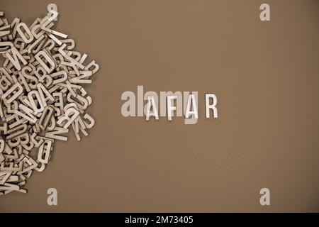 AFAR in wooden English language capital letters spilling from a pile of ...