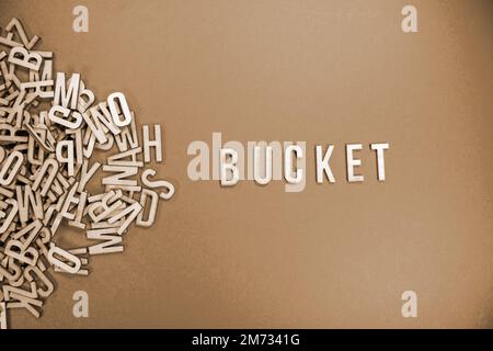 BUCKET in wooden English words language capital letters spilling from a ...