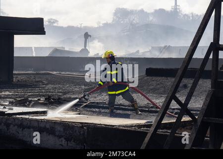 A firefighter facing a large-scale fire at the supertanker base in ...