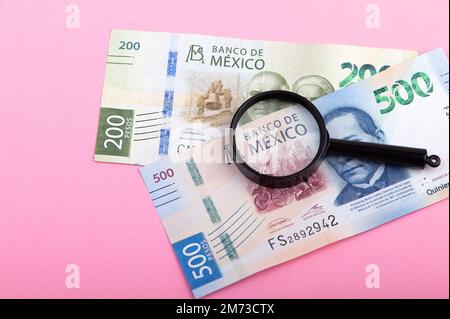 Paper currency of Mexico and magnifier on pink background, mexican ...