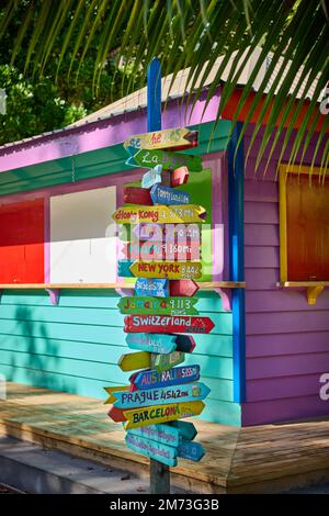 colorful information signs with distances to places around the world on ...
