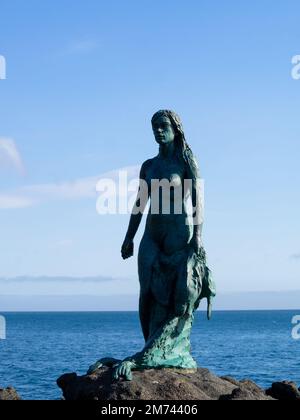 Kópakonan, the seal woman, statue over the rocks by the Kalsoyarfjørður ...