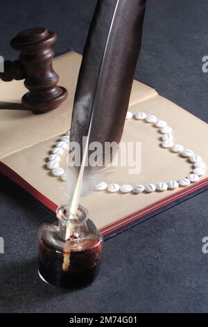 Heart symbol arranged from pills on a book. Law in medicine. Concept of ...