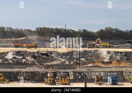 A group of construction trucks working at the site Stock Photo - Alamy