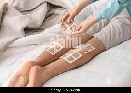 Ill young woman with mustard plaster lying in bedroom, closeup Stock ...
