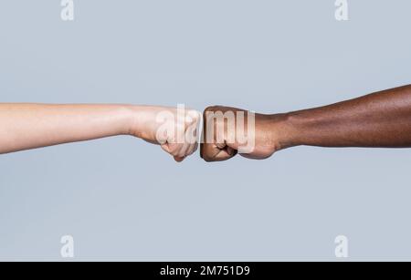 Closeup of multicultural friends giving fist bump to each other. Black ...