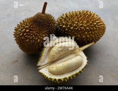 Fresh ripe durians with green leaves on white background. Tropical ...