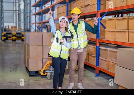 Warehouse worker pull manual pallet hand truck stack with boxes walk ...