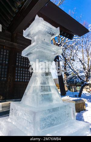 Ice sculpture of a Japanese stone lantern in the sun at Higashikawa ...