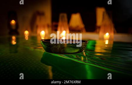 Tibetan bowl on the surface of the pool. Water relaxation and deep ...