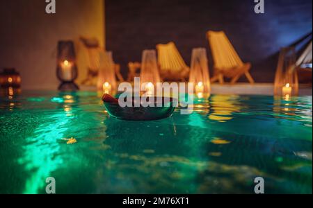 Tibetan bowl on the surface of the pool. Water relaxation and deep ...