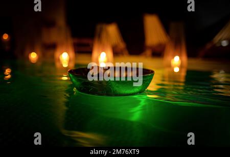 Tibetan bowl on the surface of the pool. Water relaxation and deep ...