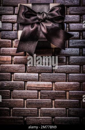 Boxed gift on wooden wicker matting holidays concept Stock Photo - Alamy