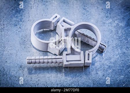 Pipe clamps on metallic background construction concept Stock Photo - Alamy