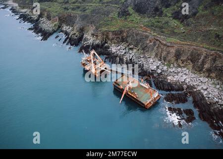 A drone view of the rusty ghost ships divided into two parts near the ...