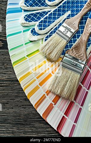 Safety gloves paint brushes color sampler on wooden board Stock Photo ...