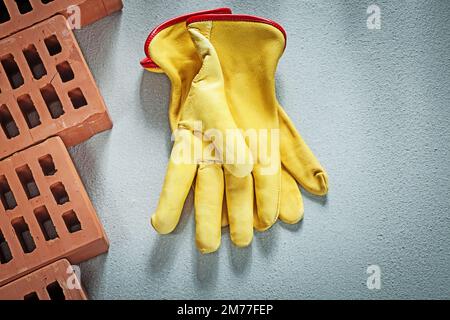 Red construction bricks safety gloves claw hammer on concrete ...