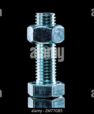 Stainless nut bolt on black surface Stock Photo - Alamy