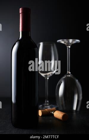 Bottle of red wine with wineglass. Water splash and droplet on the ...