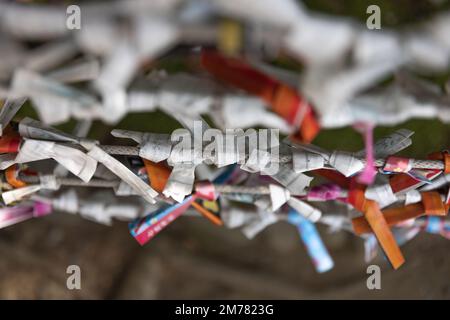 A fortune telling slip at Tomioka Shrine closeup Stock Photo - Alamy