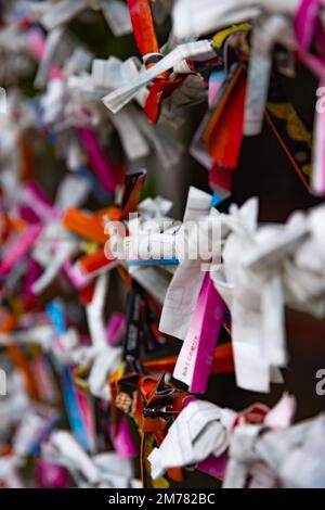 A fortune telling slip at Tomioka Shrine closeup Stock Photo - Alamy