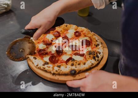 A top closeup of a newly baked pizza with sausage and cheese on the ...