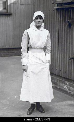 A VAD (Voluntary Aid Detachment) nurse taking care of injured men at a ...