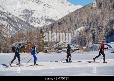 A group of cross-country skiers on a sunny winter morning on the slopes ...