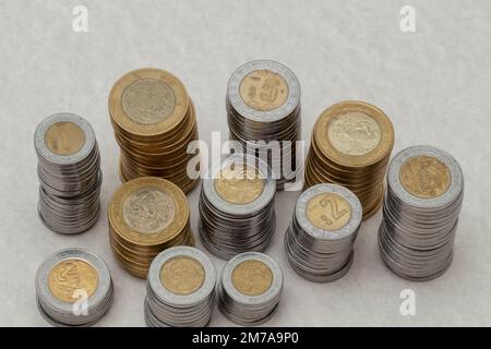 Mexican pesos coins stacked by denominations , on a table Stock Photo ...