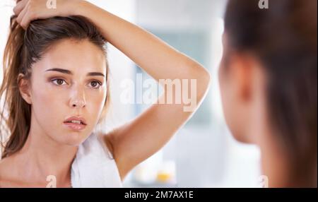 Judging beauty. Over the shoulder shot of an attractive young woman ...