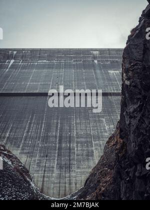 Amazing drone footage over an alpine lake, hydro dam and vast Alpine ...