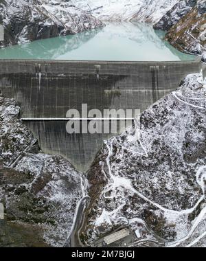 Amazing drone footage over an alpine lake, hydro dam and vast Alpine ...