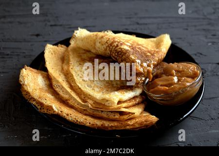 photo fried pancakes with condensed milk on a plate Stock Photo - Alamy