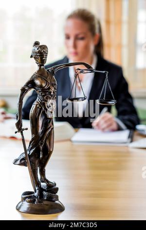 Lady Justice on the desk of a with Euro bills, corrupting, coutout ...