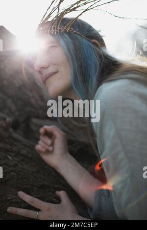 Close up ancient celtic styled woman hugging tree and praying portrait ...