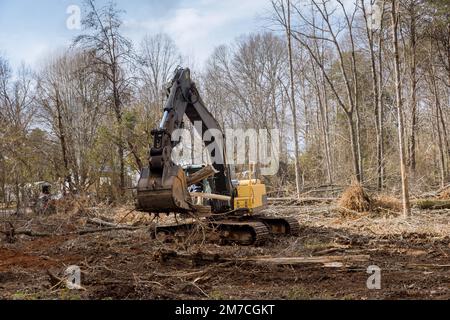 In construction site, skid steers were used to clear uprooted trees ...