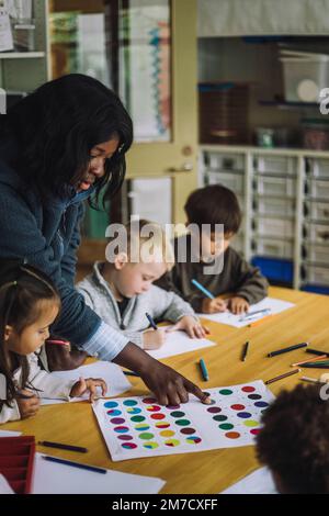 The teacher guiding students learning Stock Photo - Alamy
