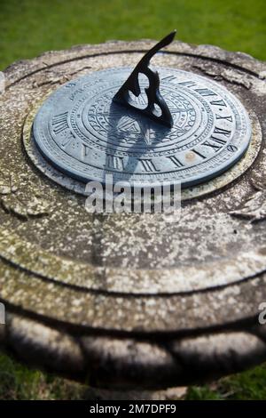 A sundial shows the time passing in agrden in the UK as the sun casts ...