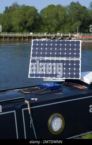 A solar panel on the roof of a long boat on the river thames at ...
