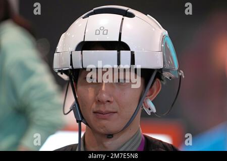 A CES attendee wears an iSync Wave EEG helmet at the iMediSync booth ...