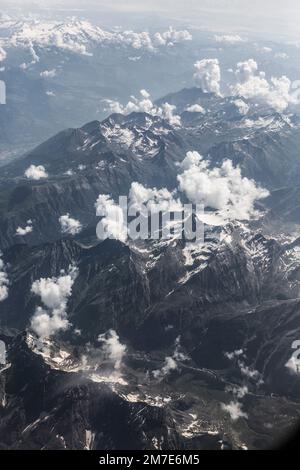 Thin wispy cloud covers The Alps mountin range as seen from an ...