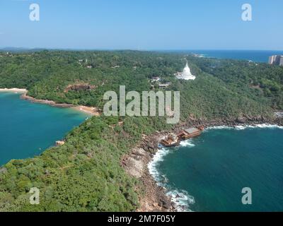 an an aerial shot over the Rumassala Sanctuary near a jungle beach ...