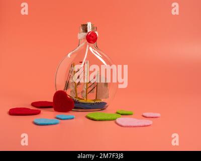 Ship in a bottle and hearts on a pink background. Close-up Stock Photo ...