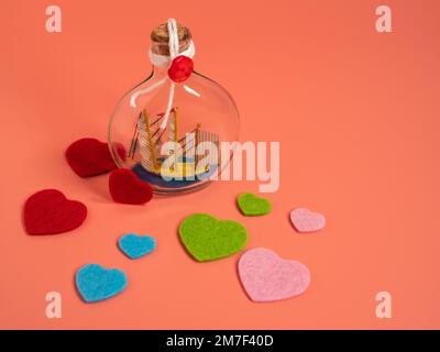Ship in a bottle and hearts on a pink background. Close-up Stock Photo ...
